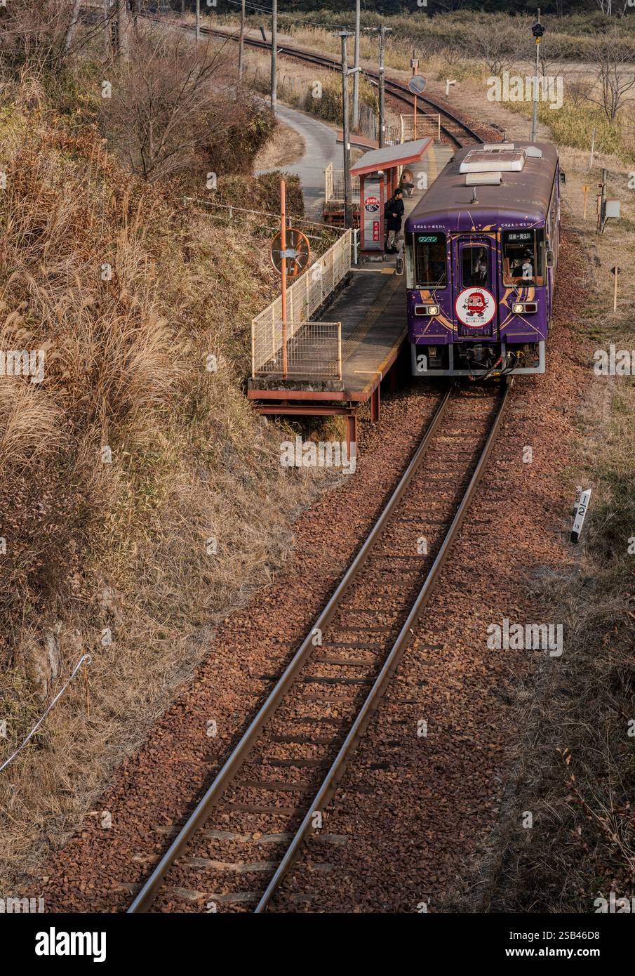 A single car diesel train stops at Gyokukeijimae Station on the ...