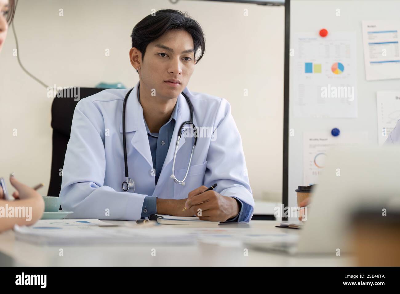 Medical doctor participating in a work meeting focused on healthcare ...