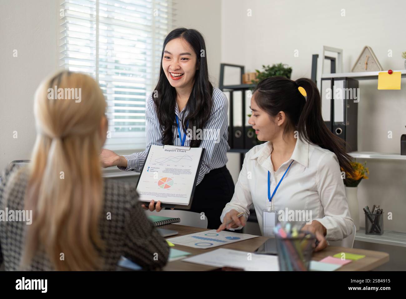 Diverse business team presenting project charts and data during a ...