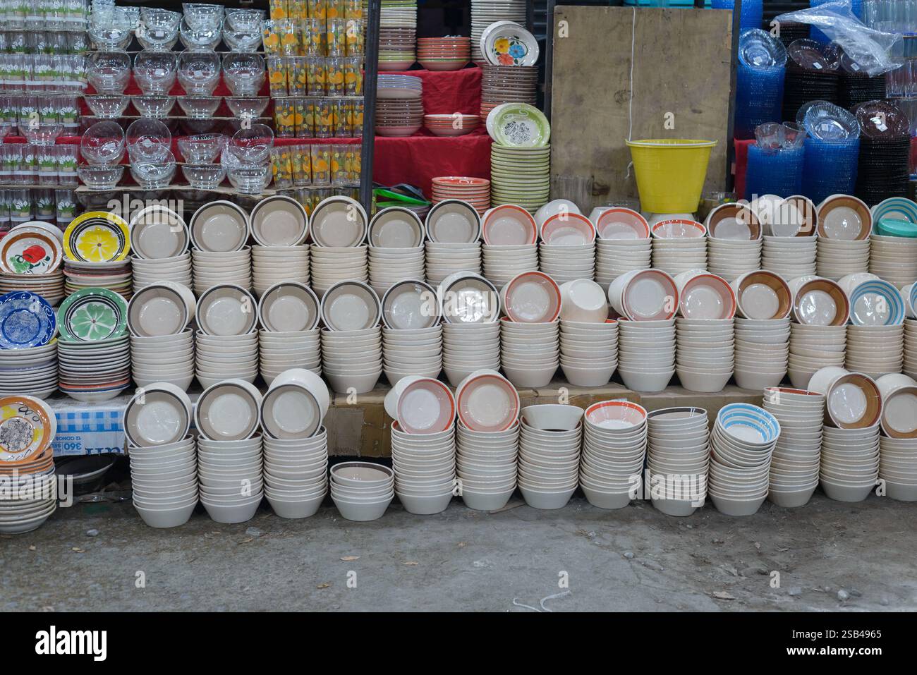 Ceramic pottery vessels stacked on the ground at a flea market in ...