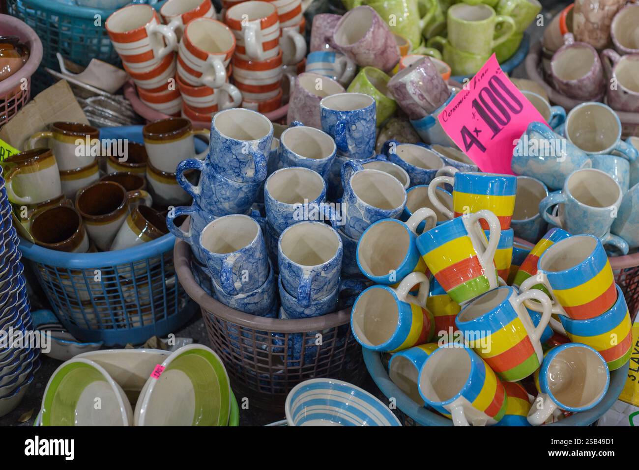 Ceramic pottery vessels stacked on the ground at a flea market in ...