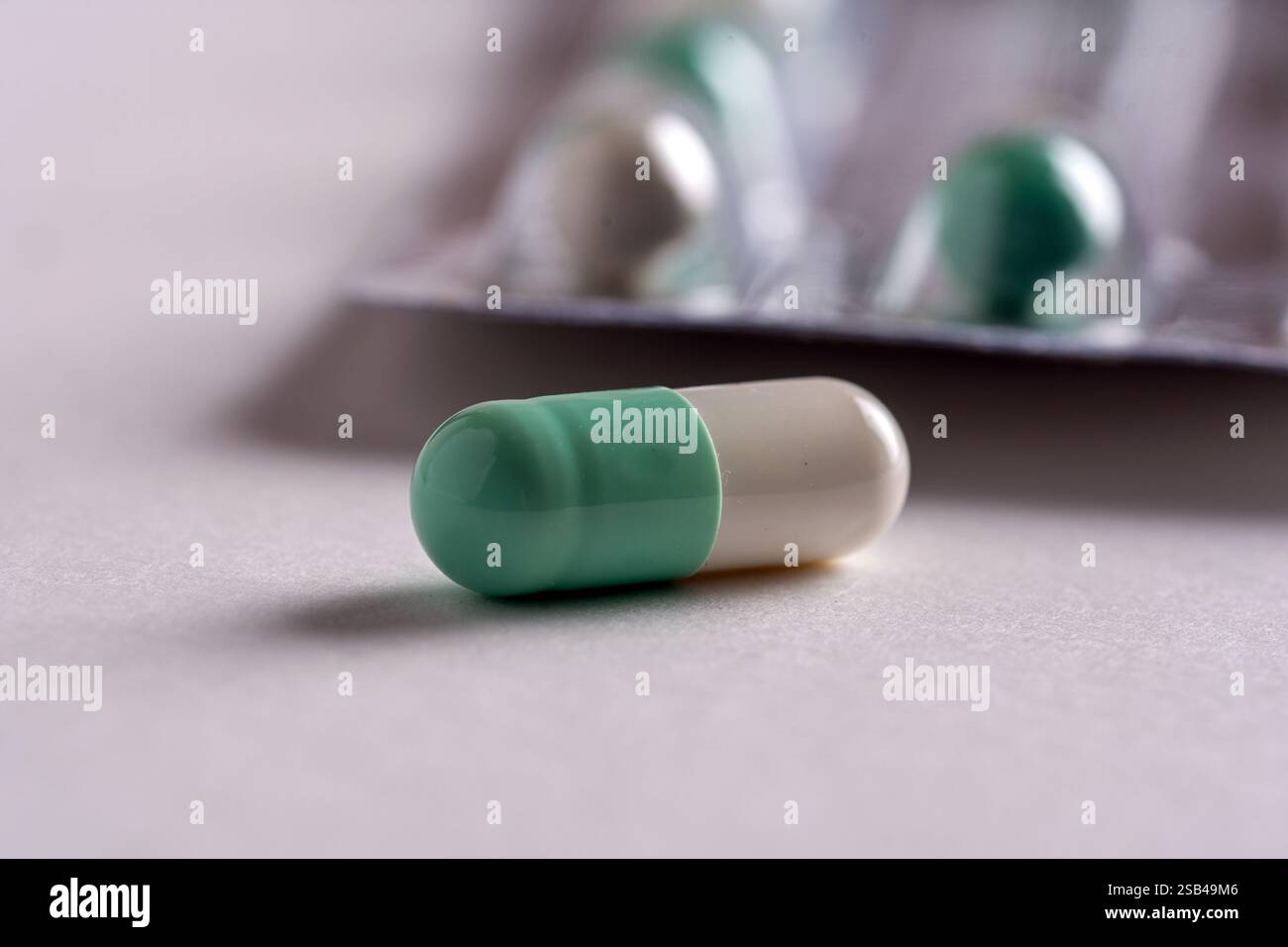 Green and White Capsule on White Background with Blister Pack Stock ...