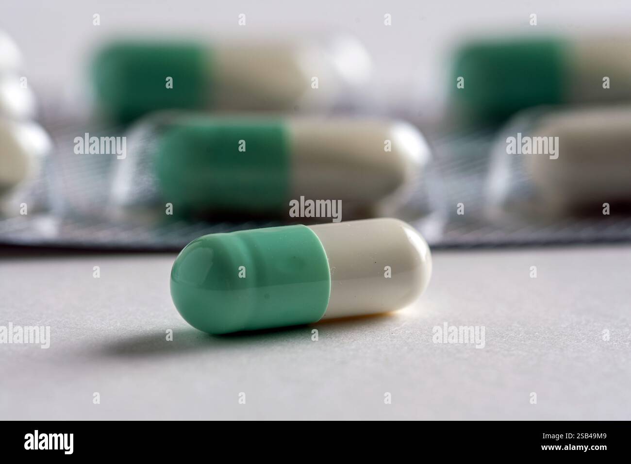 Green and White Capsule on White Background with Blister Pack Stock ...