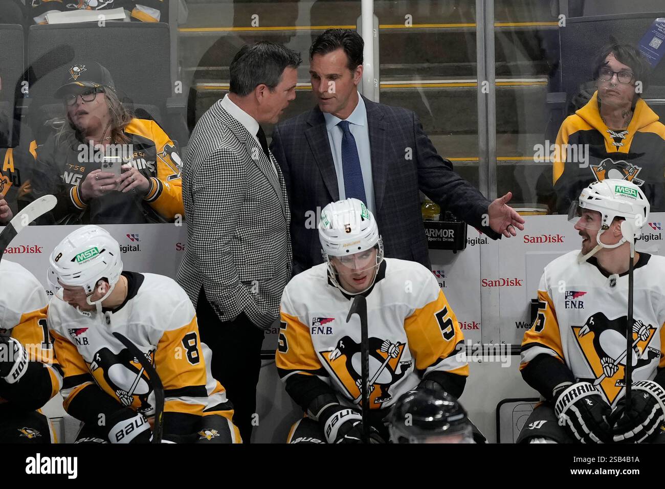 Pittsburgh Penguins head coach Mike Sullivan, from standing left, talks ...
