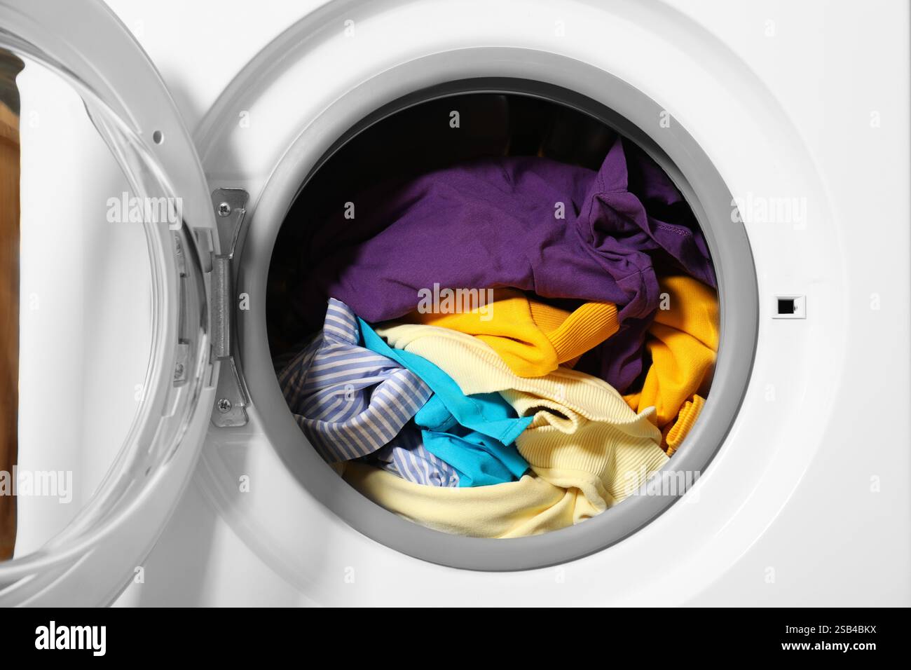 Modern washing machine with clothes in drum, closeup Stock Photo - Alamy