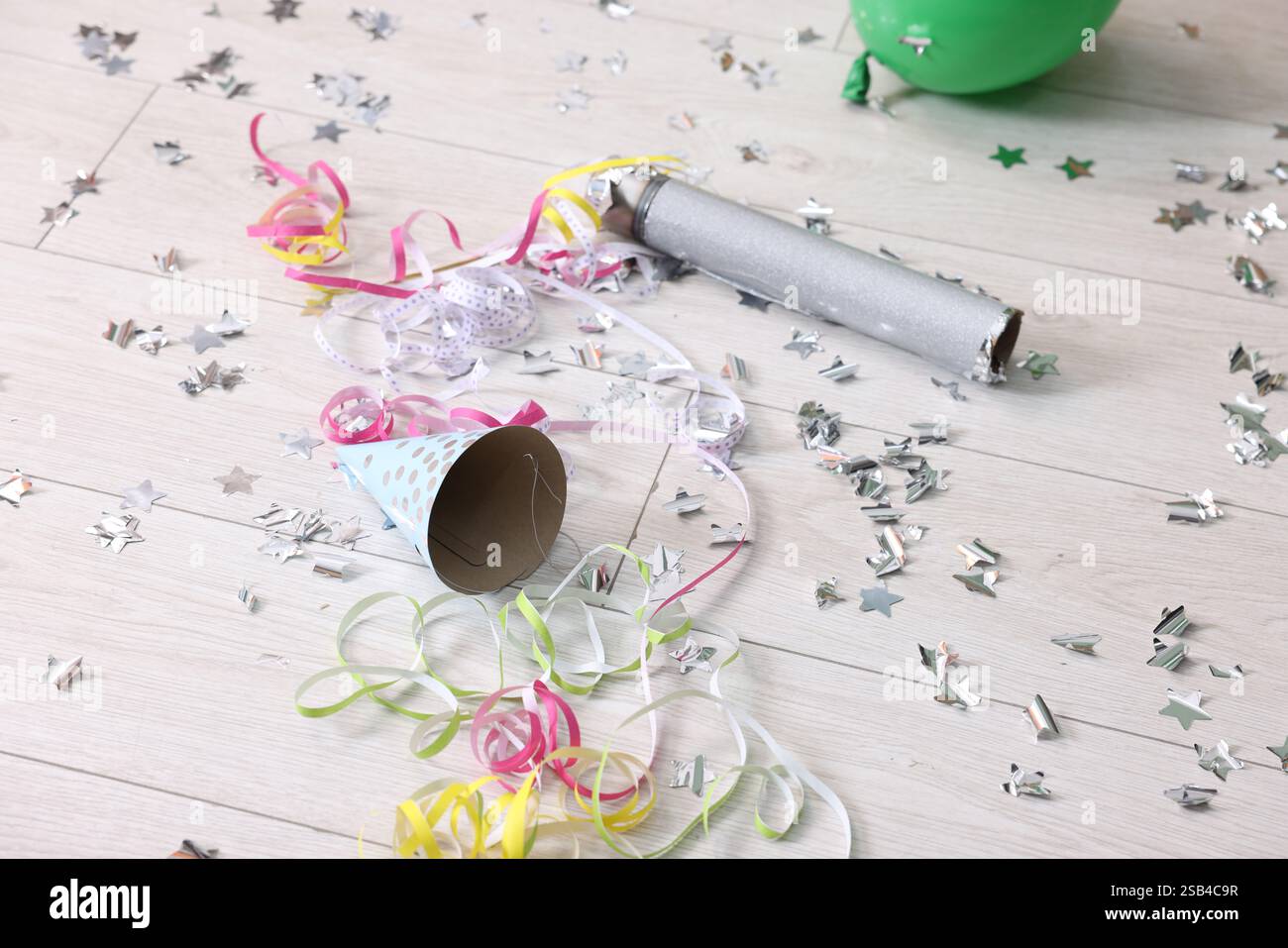 Confetti popper, serpentine streamers and other party decor on floor ...