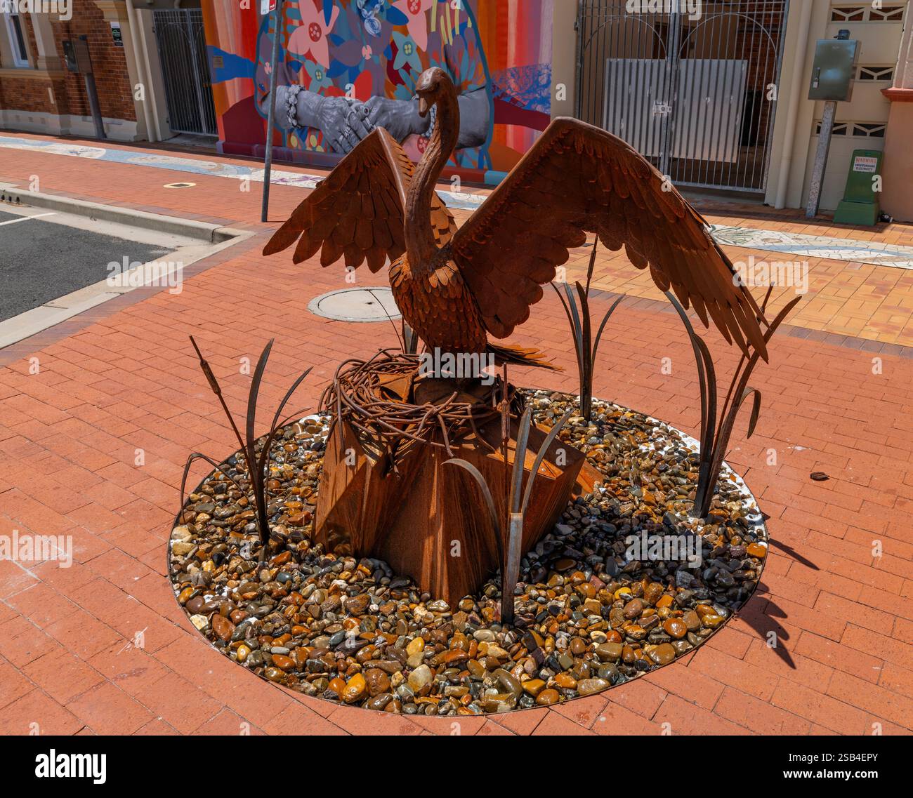 The sculpture depicts a swan atop of rocks surrounded by 5 bullrushes ...