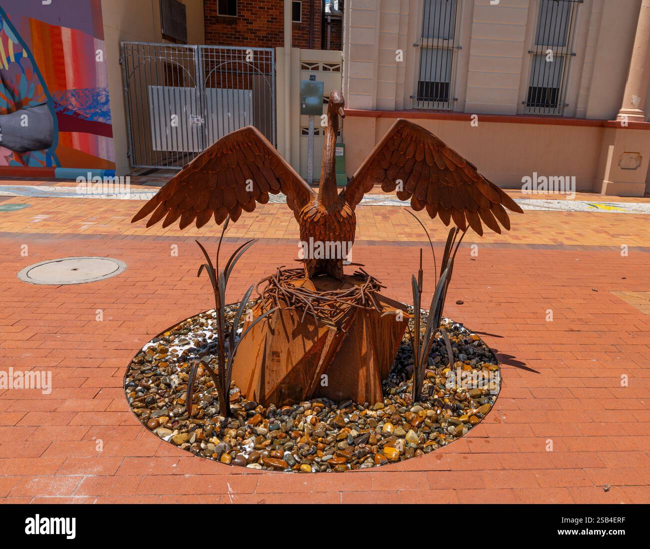 The sculpture depicts a swan atop of rocks surrounded by 5 bullrushes ...
