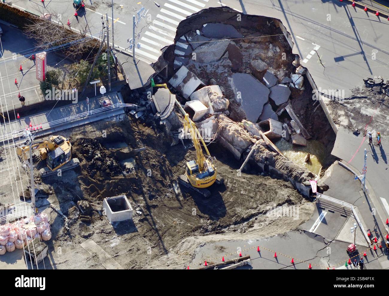 An aerial photo shows sinkholes at an intersection in Yashio City ...