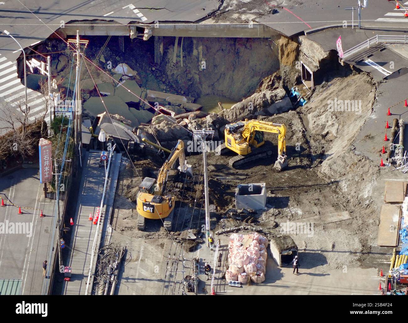 An aerial photo shows sinkholes at an intersection in Yashio City ...