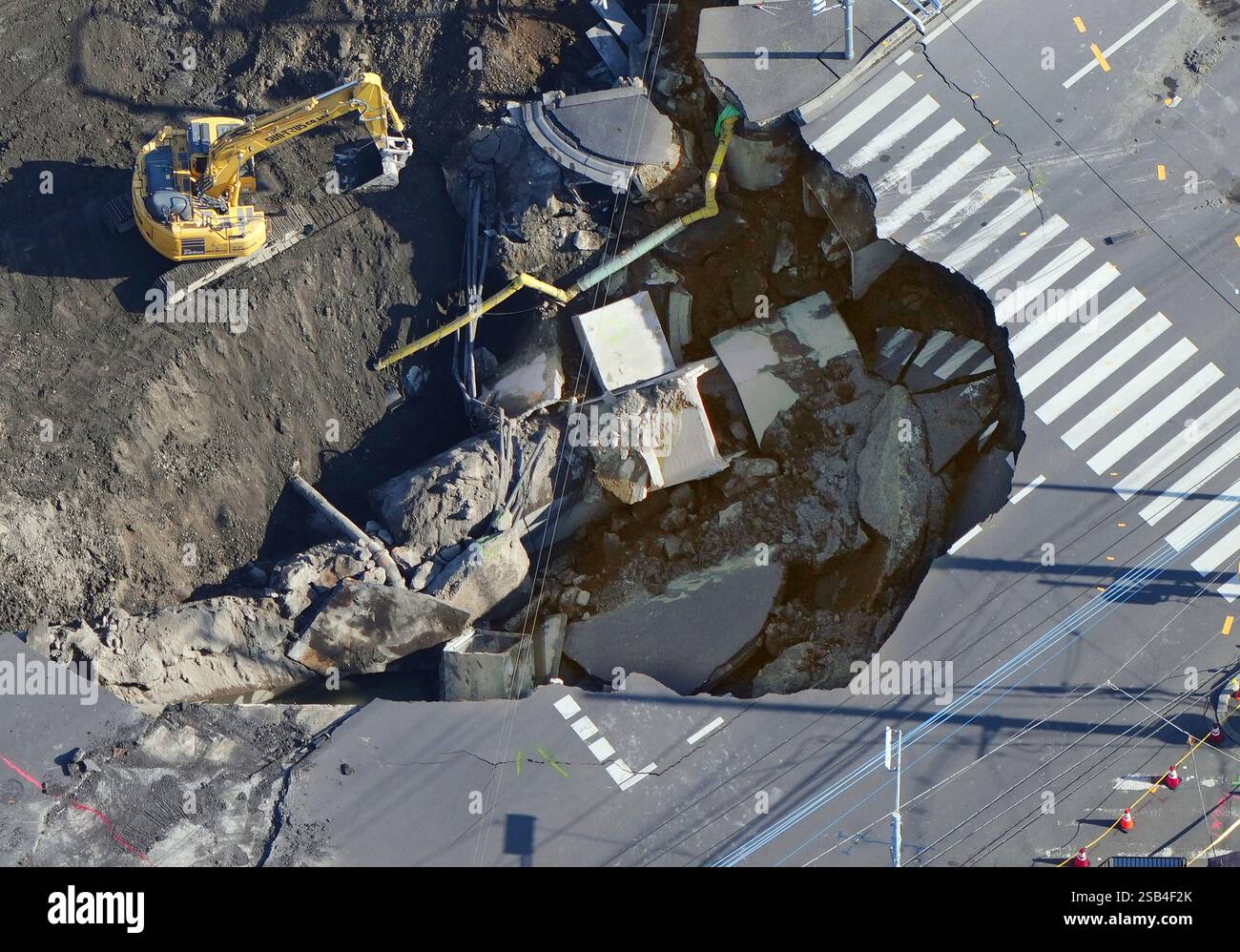 An aerial photo shows sinkholes at an intersection in Yashio City ...