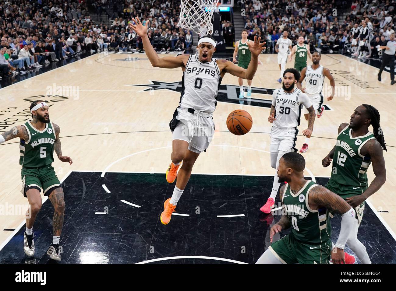 San Antonio Spurs forward Keldon Johnson (0) loses control of the ball ...