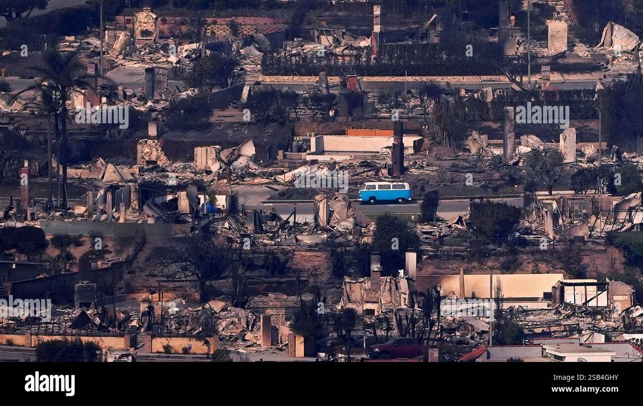 The color of a Volkswagen bus stands out amid the charred ruin of homes in Malibu, California ...