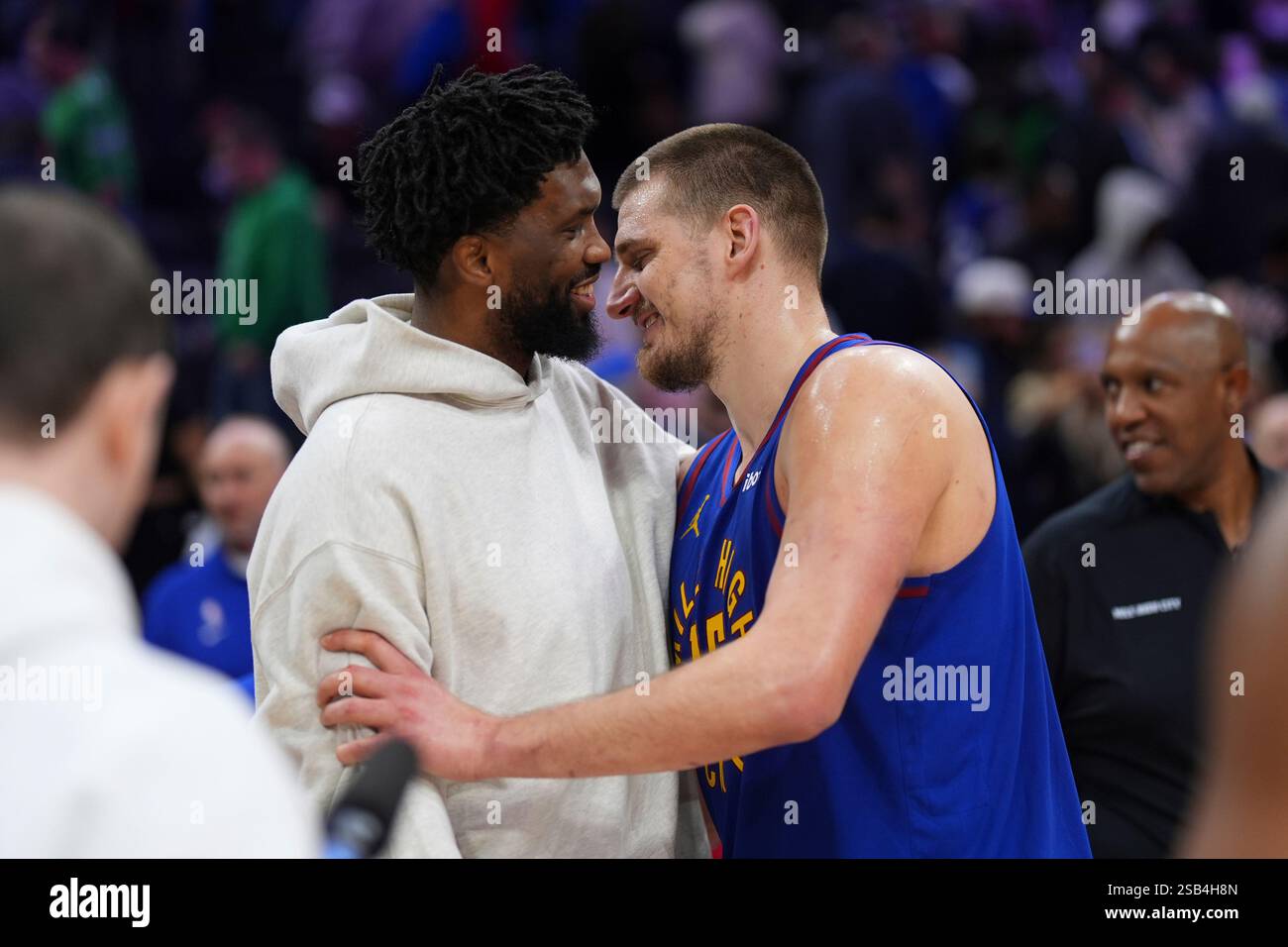 Philadelphia 76ers' Joel Embiid, left, and Denver Nuggets' Nikola Jokic ...