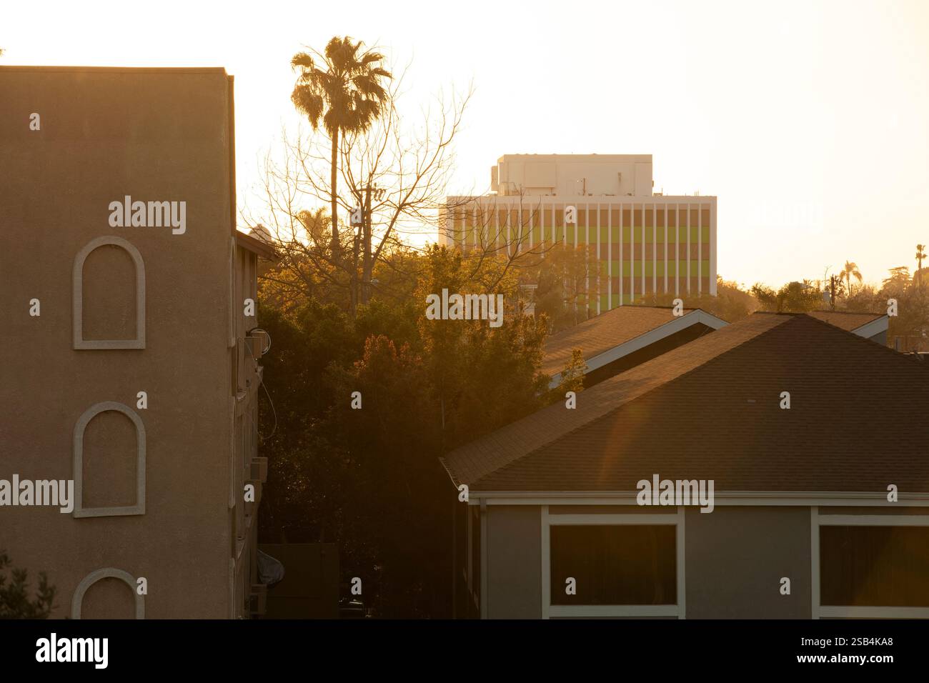 The sun sets on the downtown skyline buildings of Santa Ana, California ...