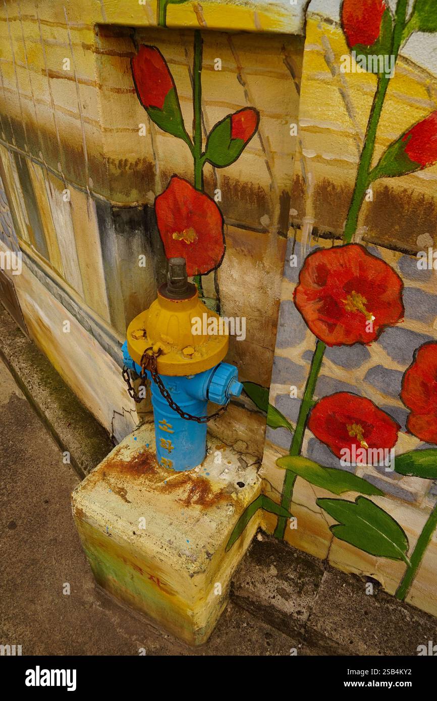 a picture of flowers on the wall and a colorful fire hydrant Stock ...