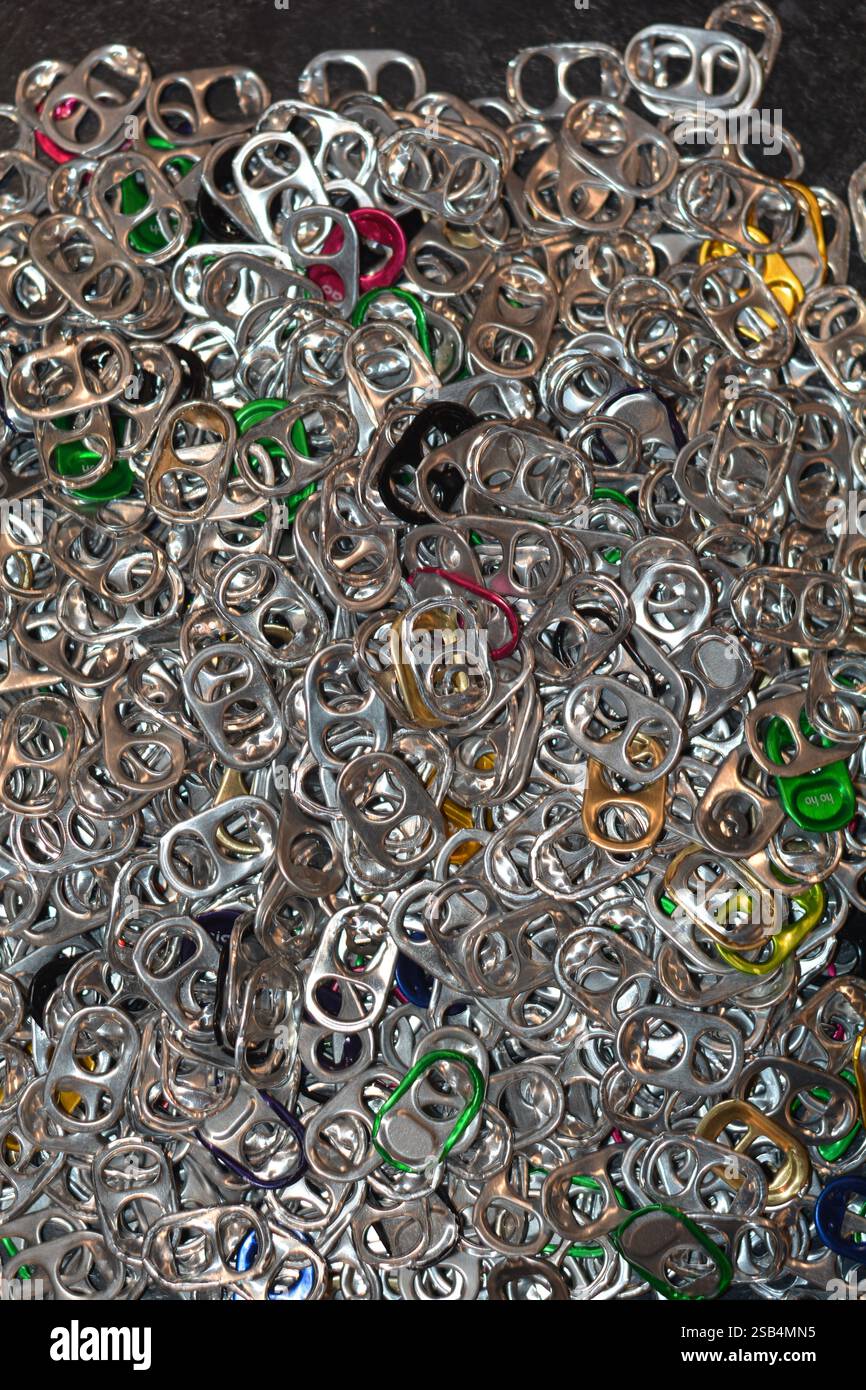 A pile of hundreds of drink tabs from aluminum soft drink (soda) and ...