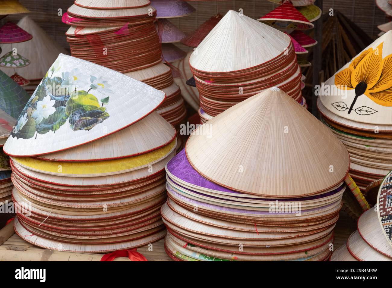 Traditional Vietnamese conical leaf hats for sale in market, warm ...