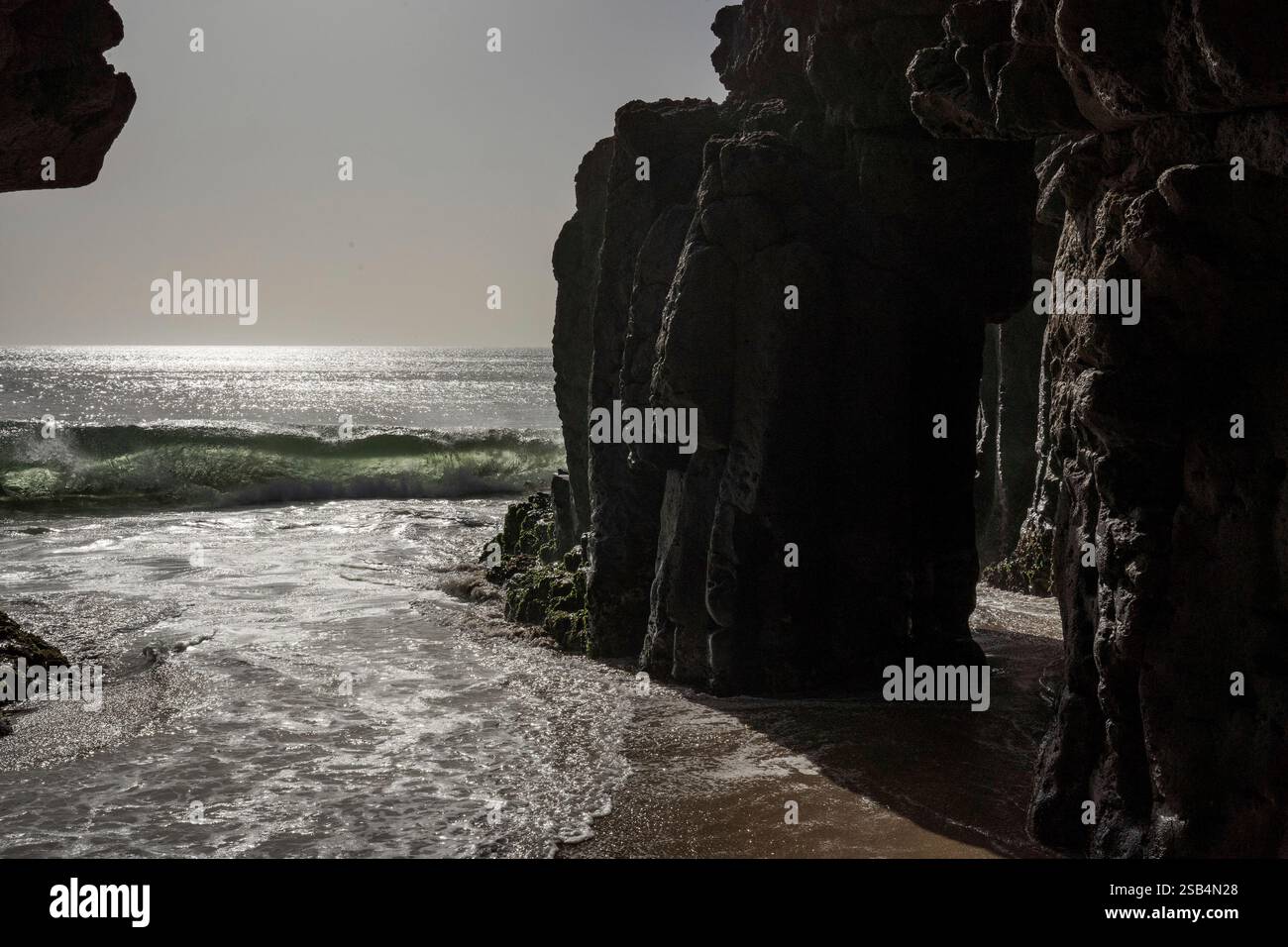 Waves from the Atlantic ocean break on a scared grotto where followers ...