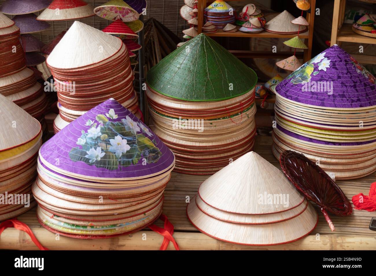 Traditional Vietnamese conical leaf hats for sale in market, warm ...