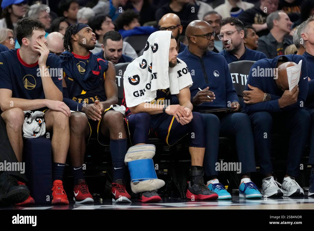 Golden State Warriors center Quinten Post, left, reacts on the bench ...