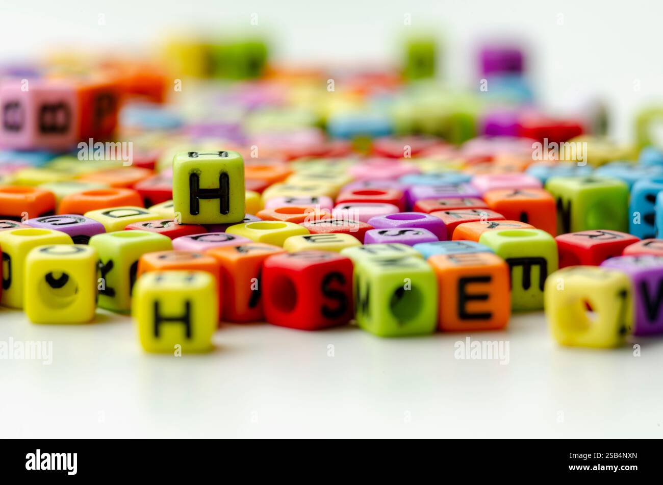 Colorful plastic alphabet beads with letters printed on them Stock ...