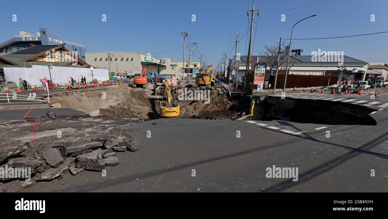 A photo shows the site of a road collapsed above huge sinkholes at an ...