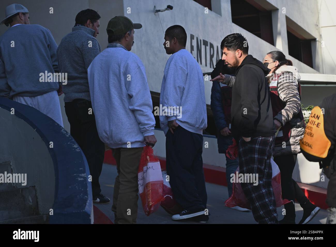 Deported migrants walk as they arrive at the Flamingo plaza's Attention ...