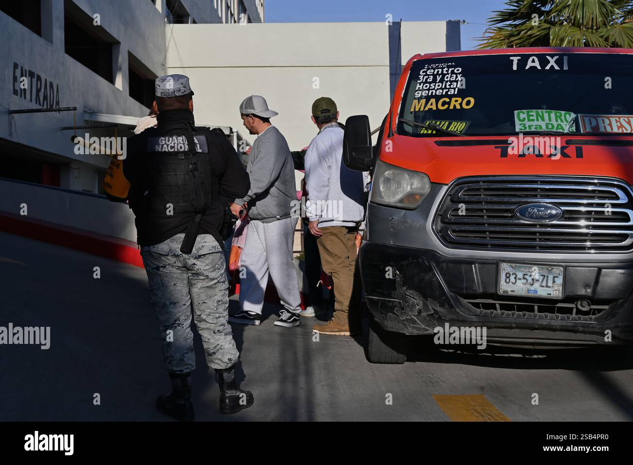 Deported migrants walk as they arrive at the Flamingo plaza's Attention ...