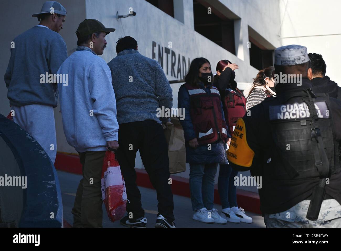 Deported migrants walk as they arrive at the Flamingo plaza's Attention ...