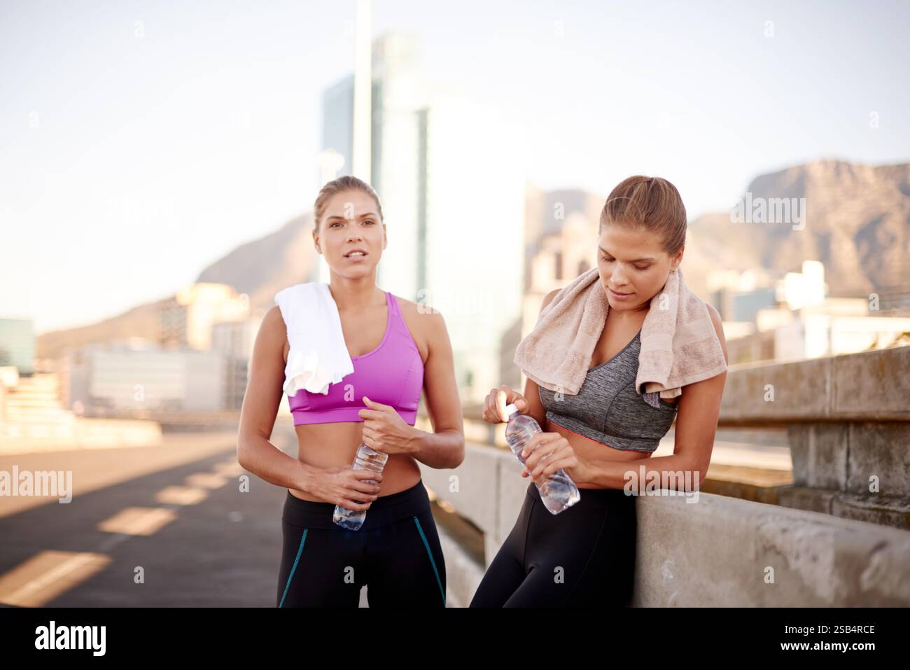 Workout, city and women on road with water break for marathon training ...