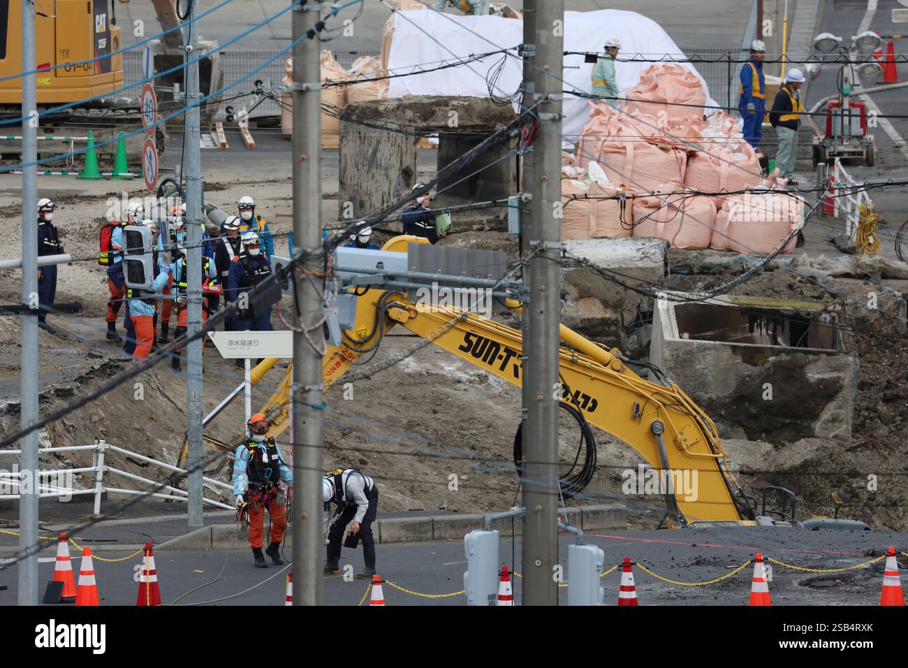 A photo shows the site of a road collapsed above huge sinkholes at an ...