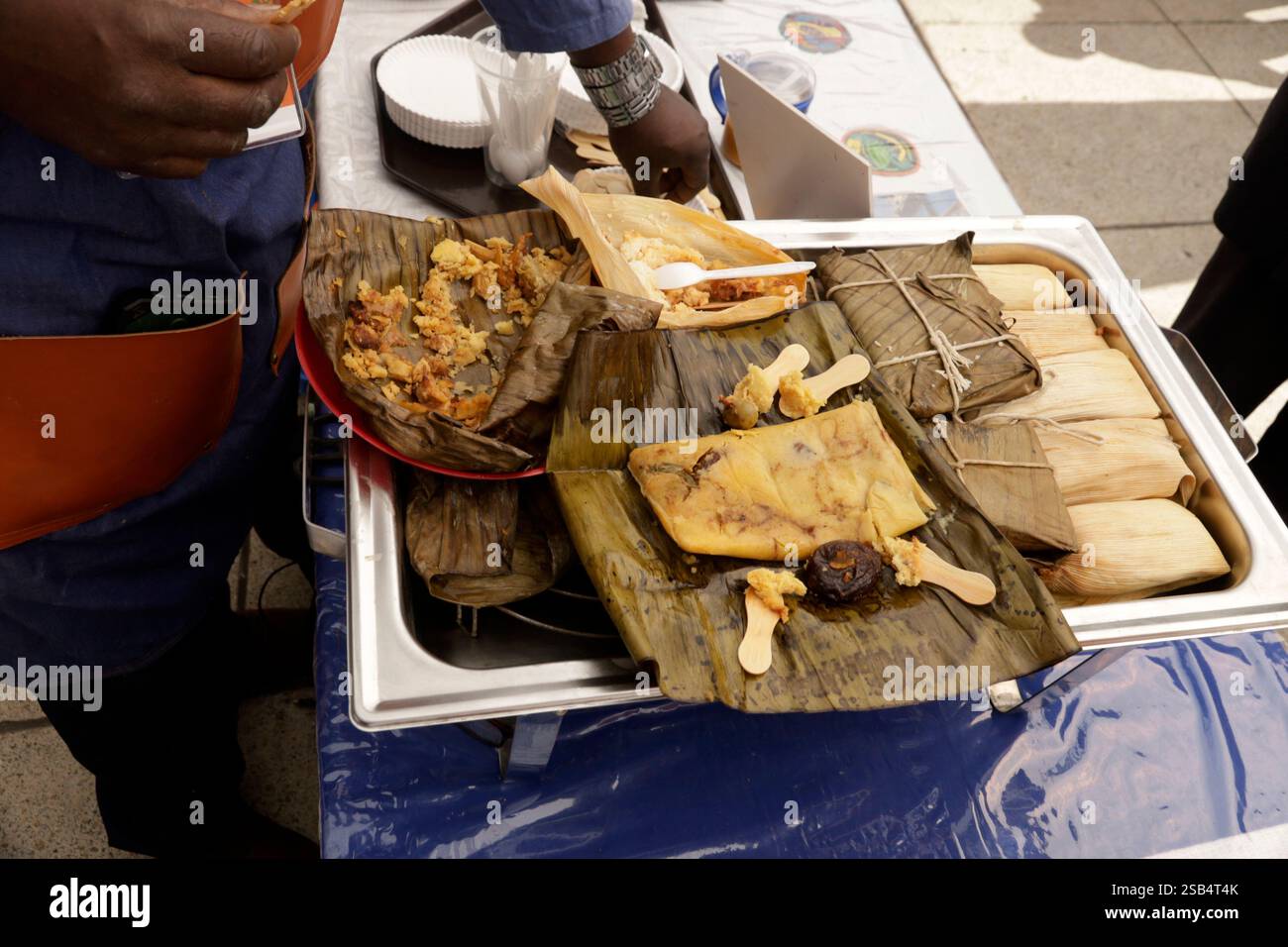 A vendor shows a tamale at the first Tamale Fair as part of the ...