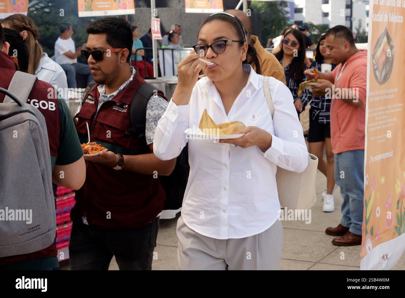A person eats a tamale at the first Tamale Fair as part of the ...