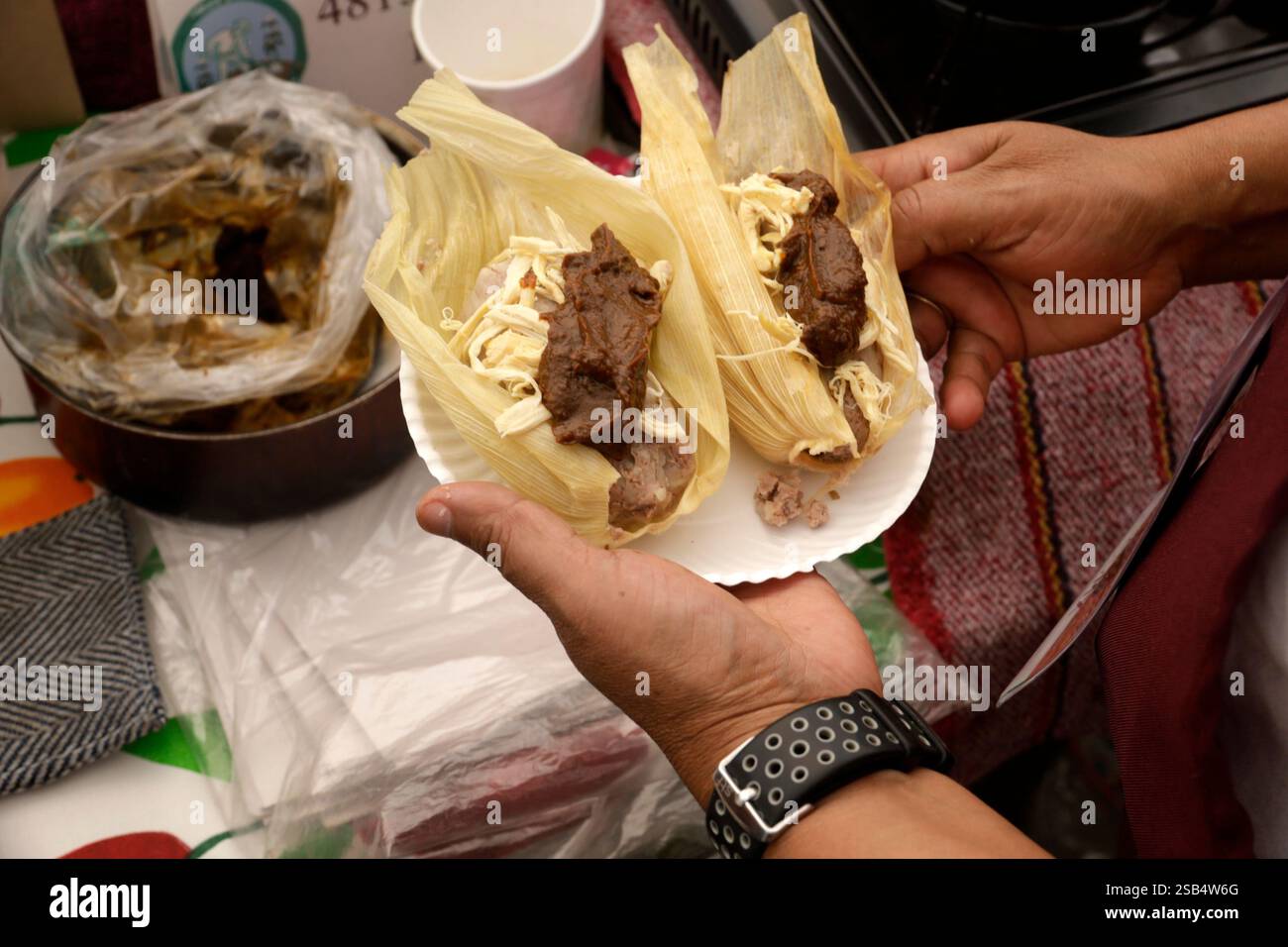 A vendor shows a tamale at the first Tamale Fair as part of the ...