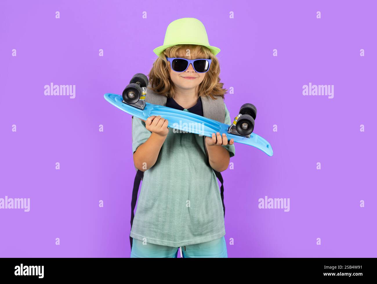 Child with skateboard in the studio. Kid having fun with penny board ...