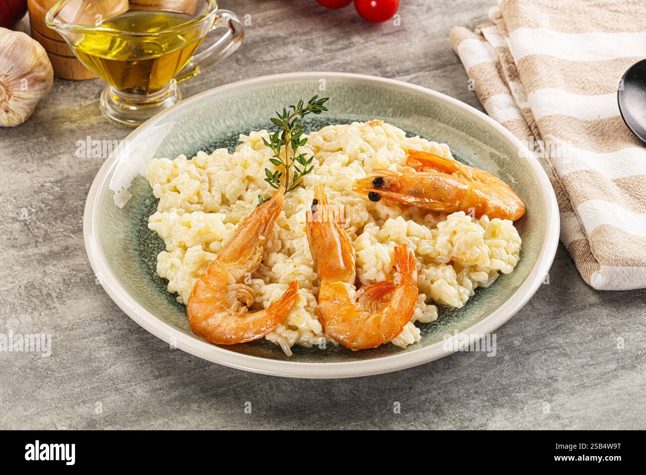 Italian cuisine - risotto with prawn served thyme Stock Photo - Alamy