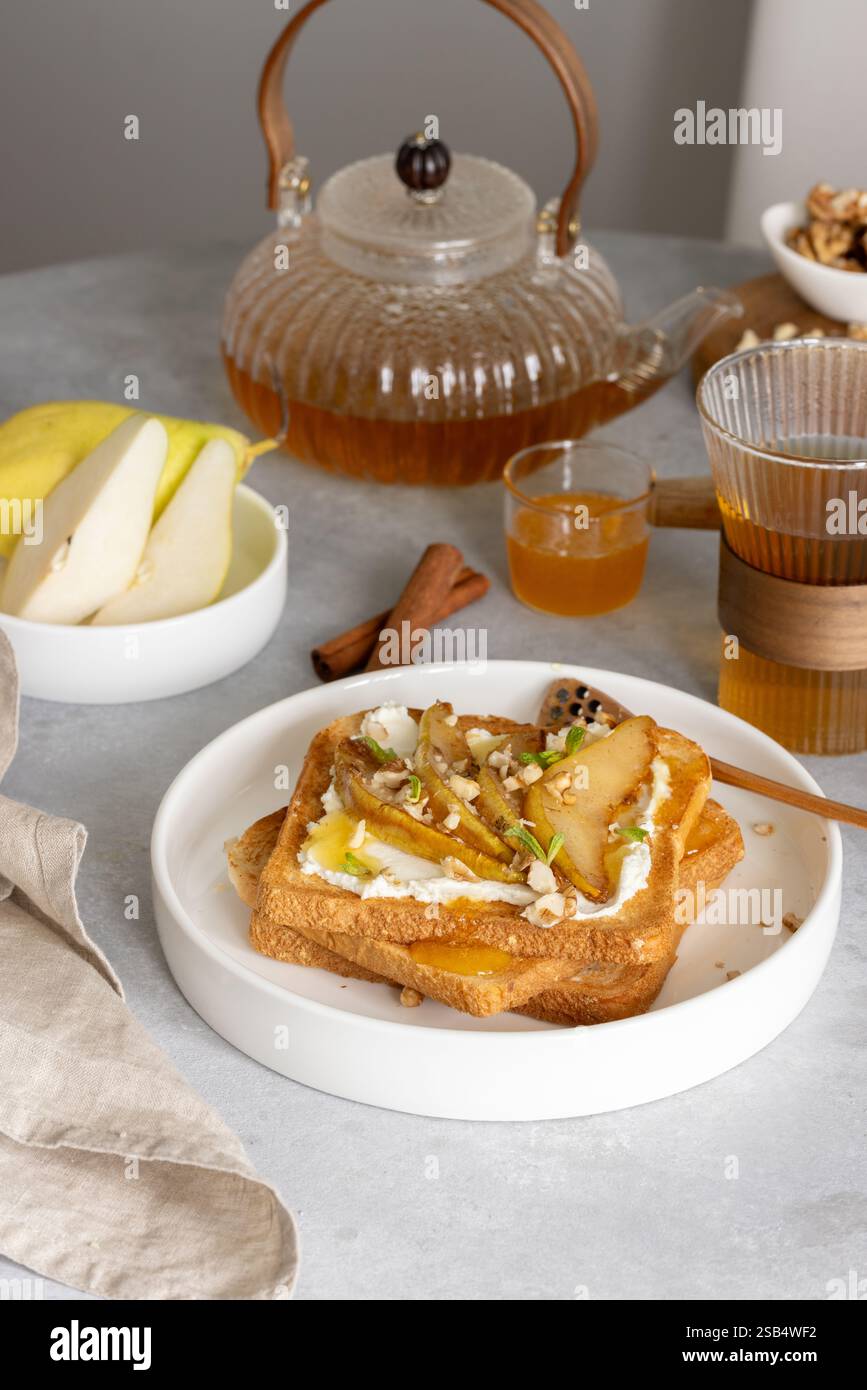Breakfast with cream cheese toasts and caramelized pears, honey and ...
