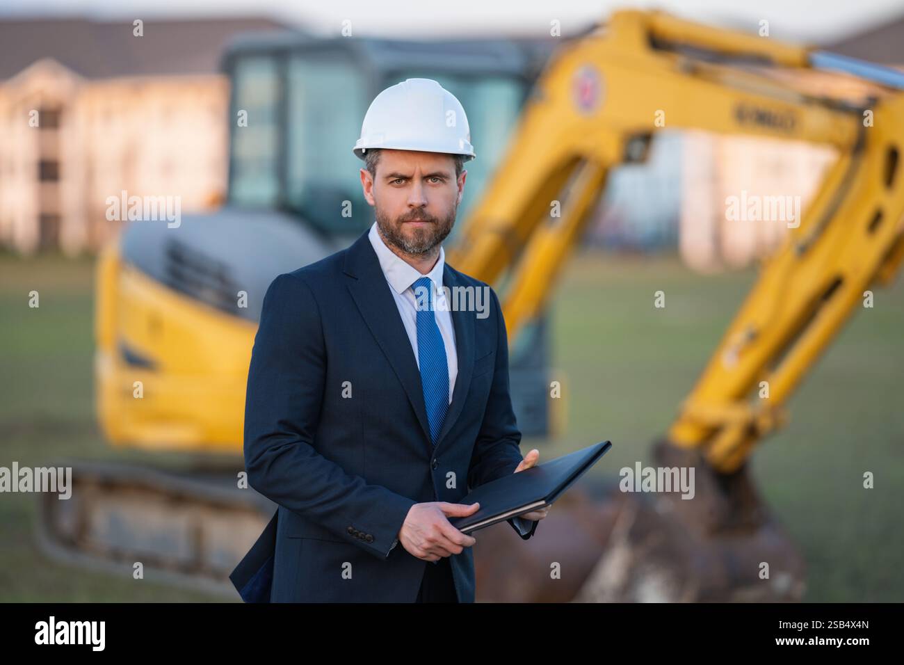 Construction business owner. Man in suit and hardhat halmet at building ...