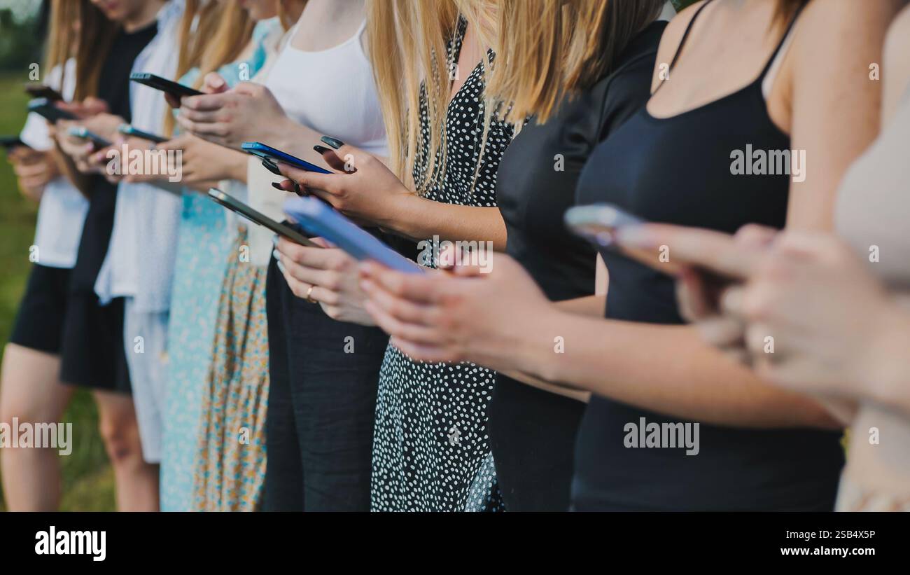 Group of students standing in a line outdoors, enjoying summer while ...