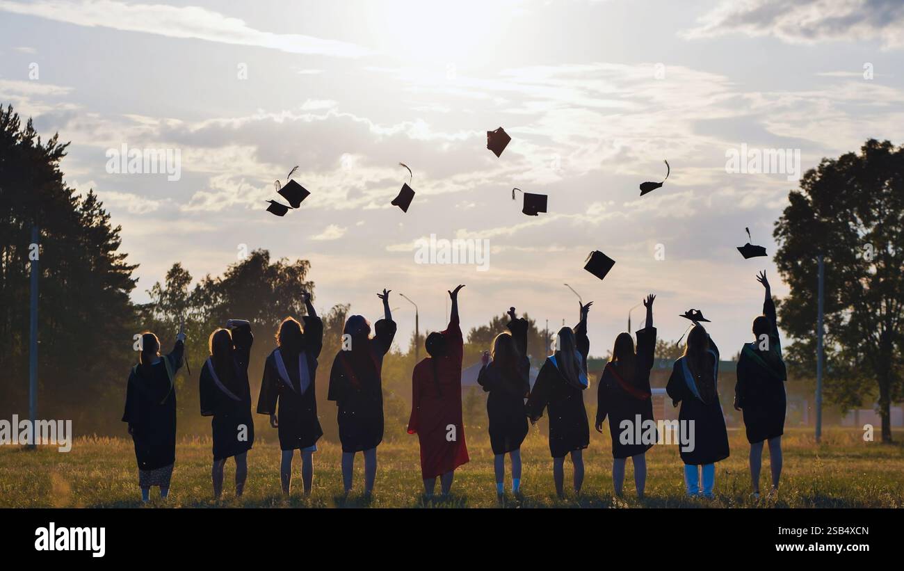 Group of students celebrating graduation by throwing their mortarboards ...