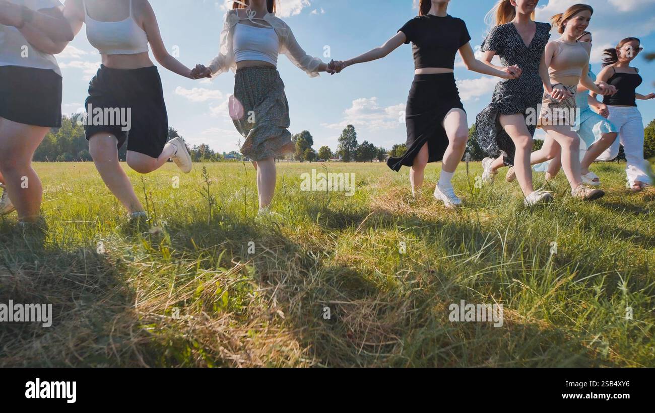 Female high school students holding hands and running together in a ...