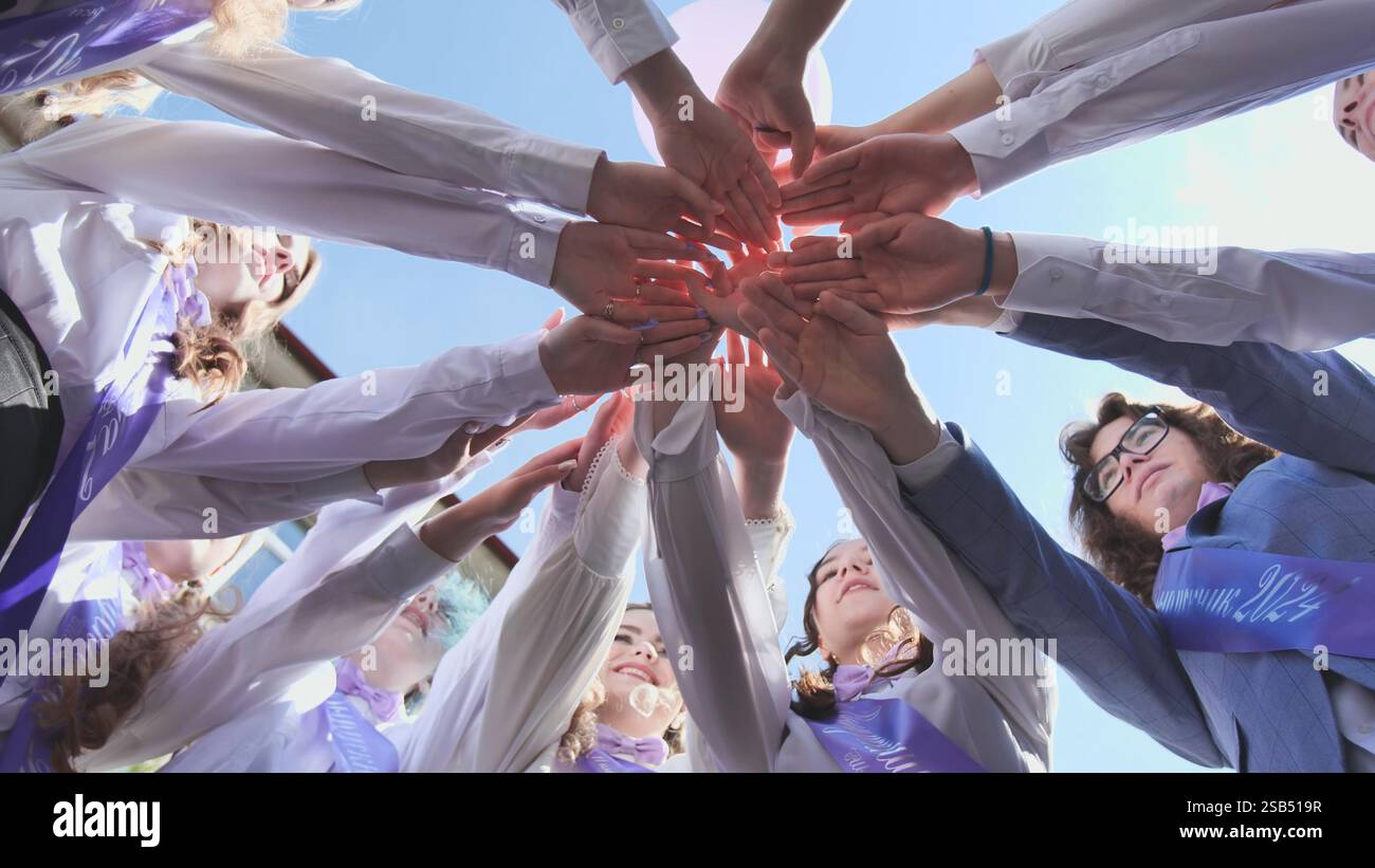 Students coming together in a circle, celebrating their final day of ...
