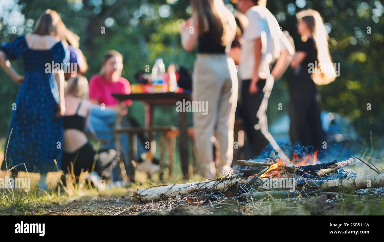 Group of blurred students celebrating their graduation with a bonfire ...