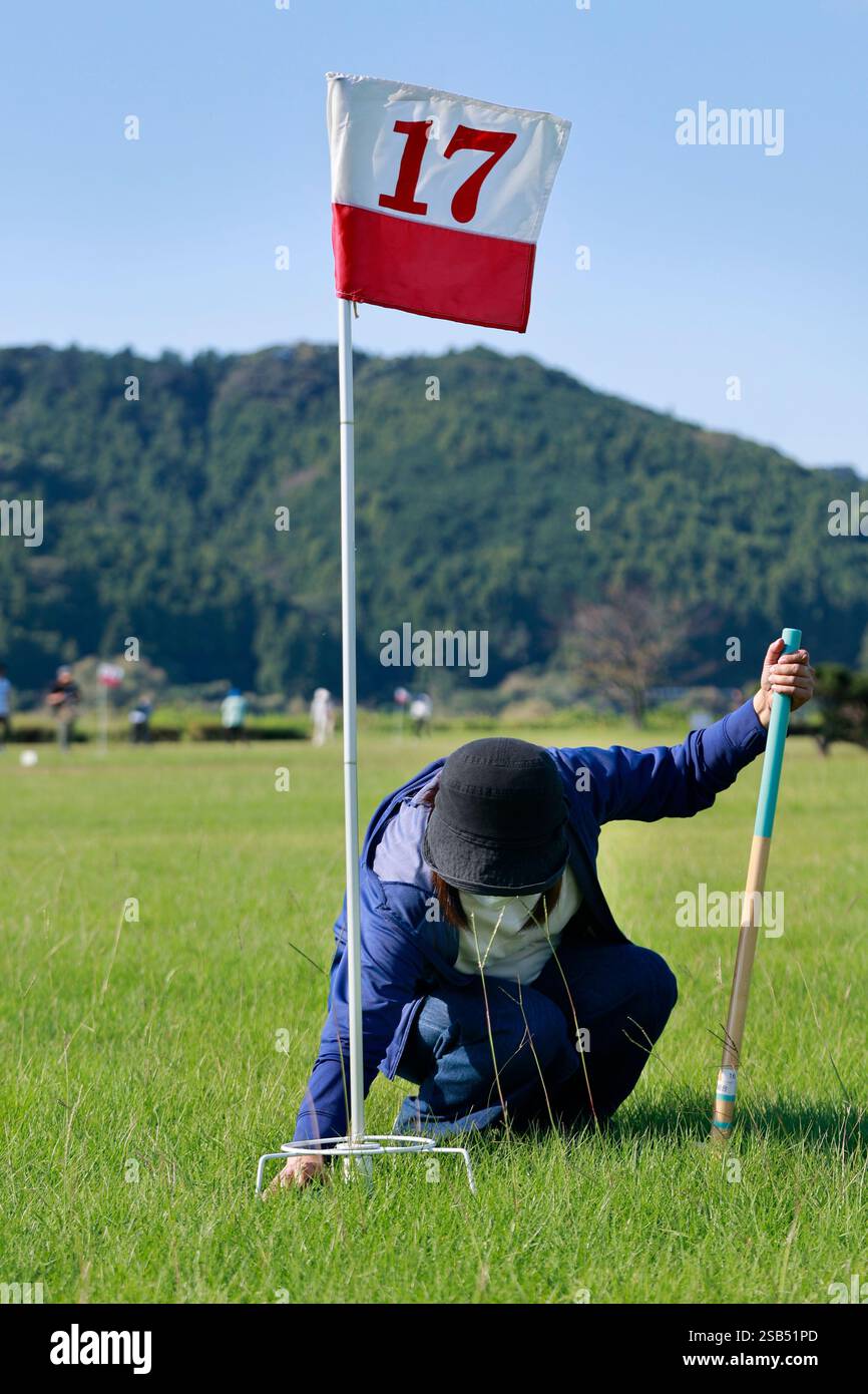 Old japanee woman playing gate ball at the gate 17 on gateball field ...