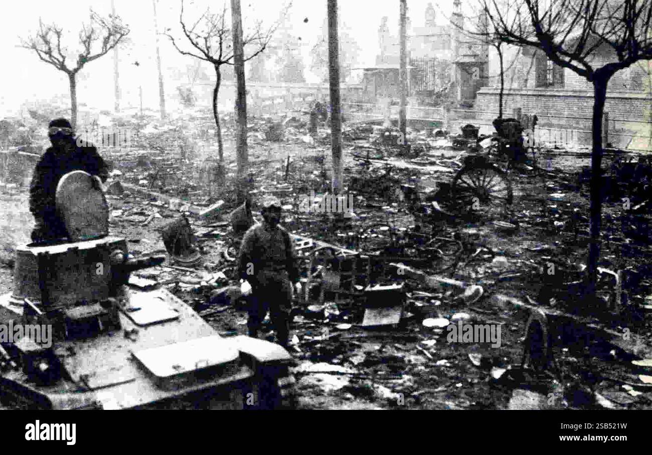A Japanese soldier walking through debris scattered on Nanking's ...