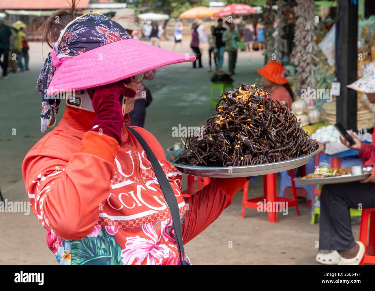 A woman with a tray of Deep-fried Tarantula spiders in Cheung Prey ...