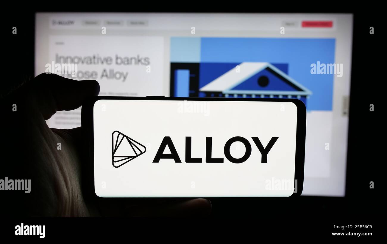 In this photo illustration, a person is holding a mobile phone with the ...