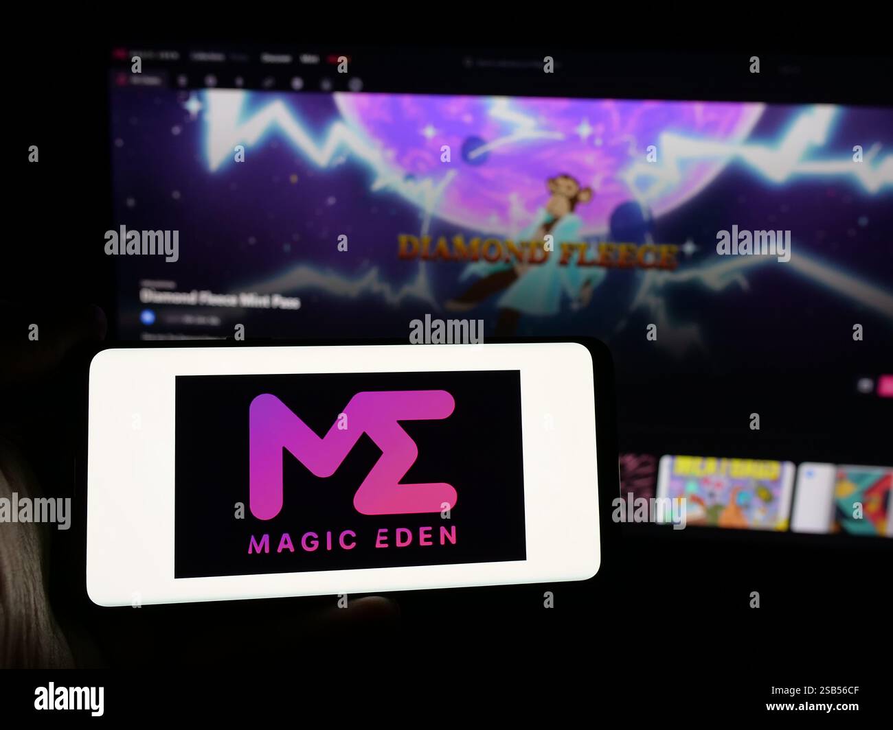 In this photo illustration, a person is holding a smartphone with the logo of NFT company ...