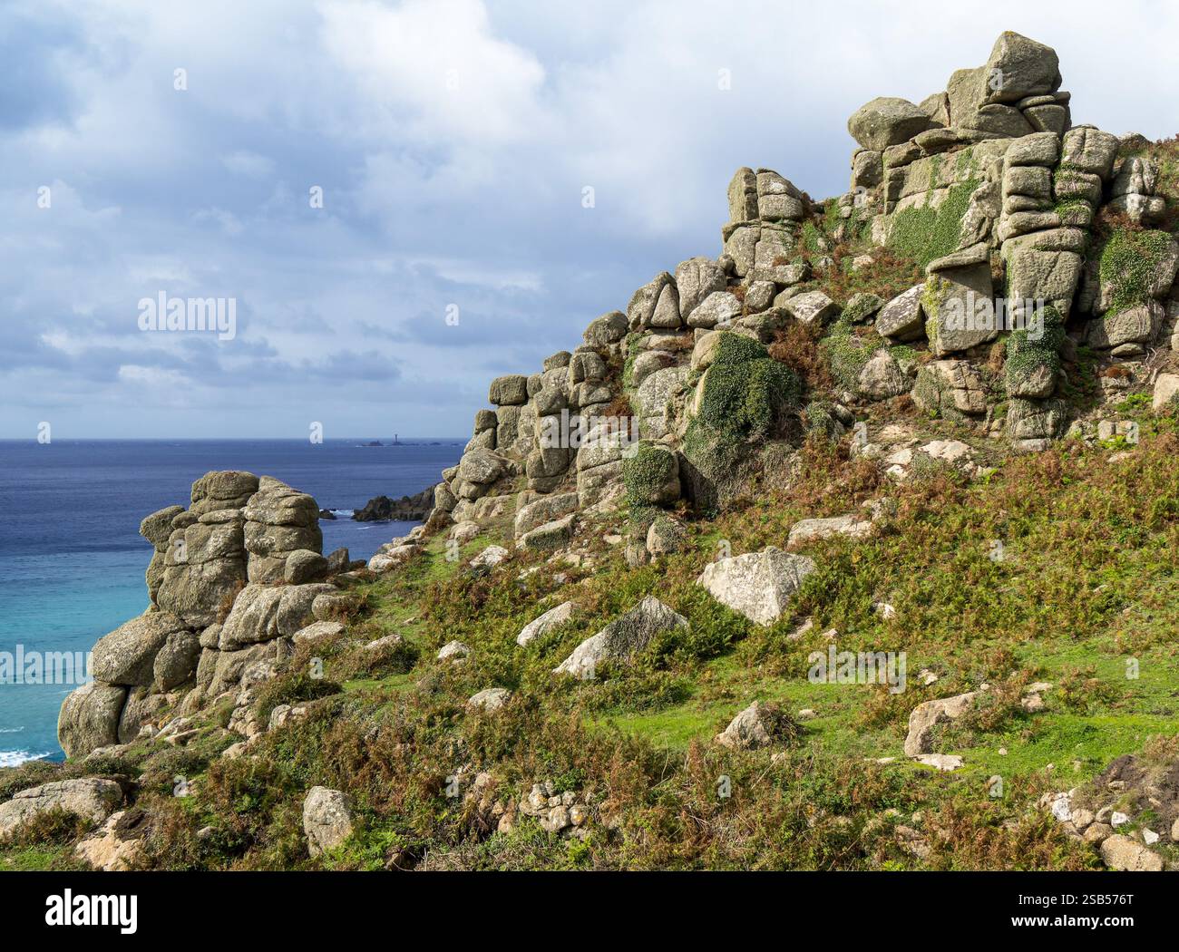 Cornish granite cliffs and Torrs with Longships Lighthouse in the ...